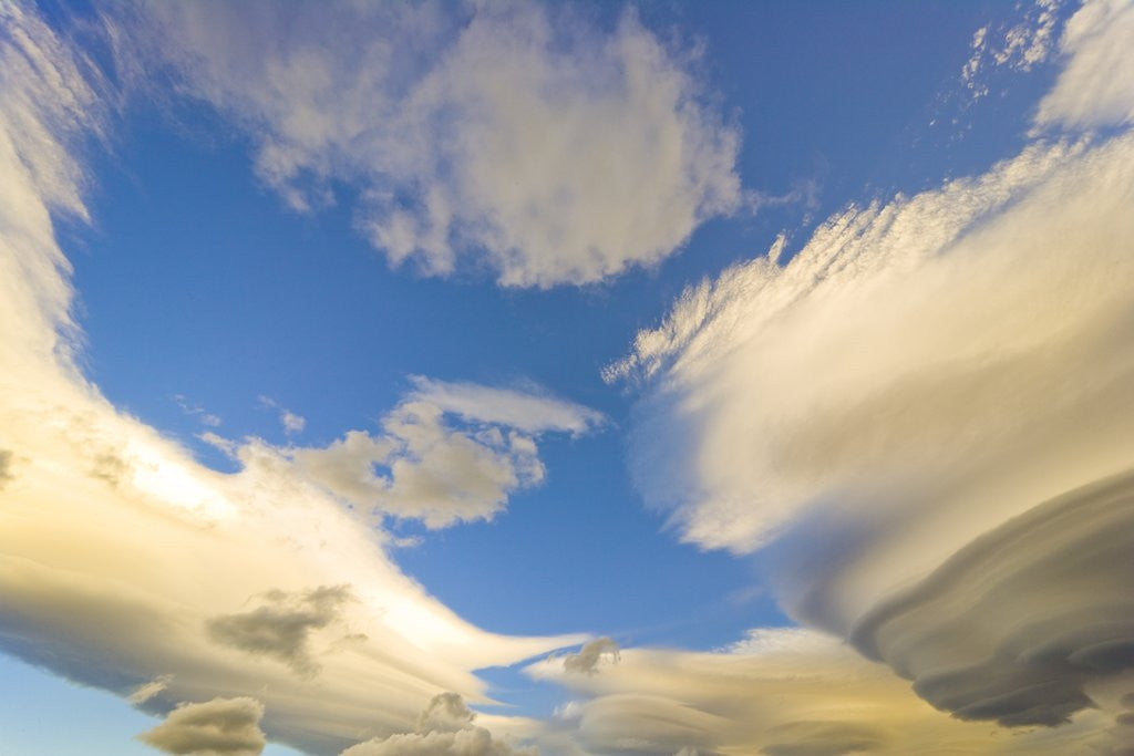 Cumulus and Lenticular Clouds at Sunrise posters & prints by Anonymous