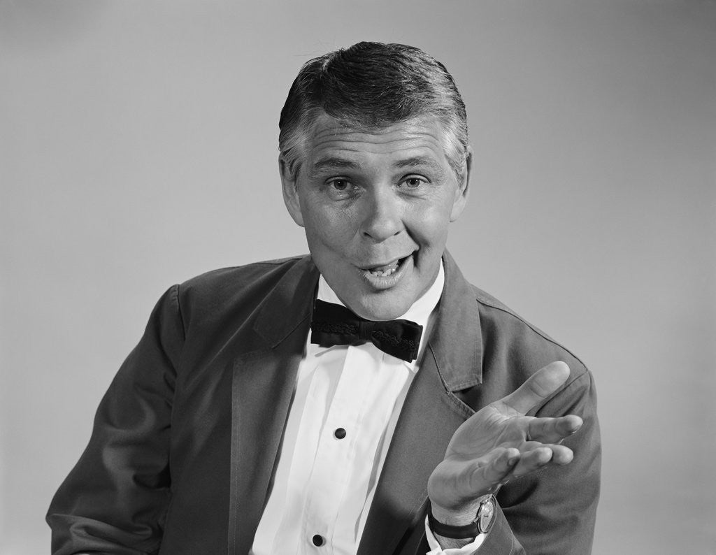 Portrait man wearing bow tie quizzical facial expression & gesture ...